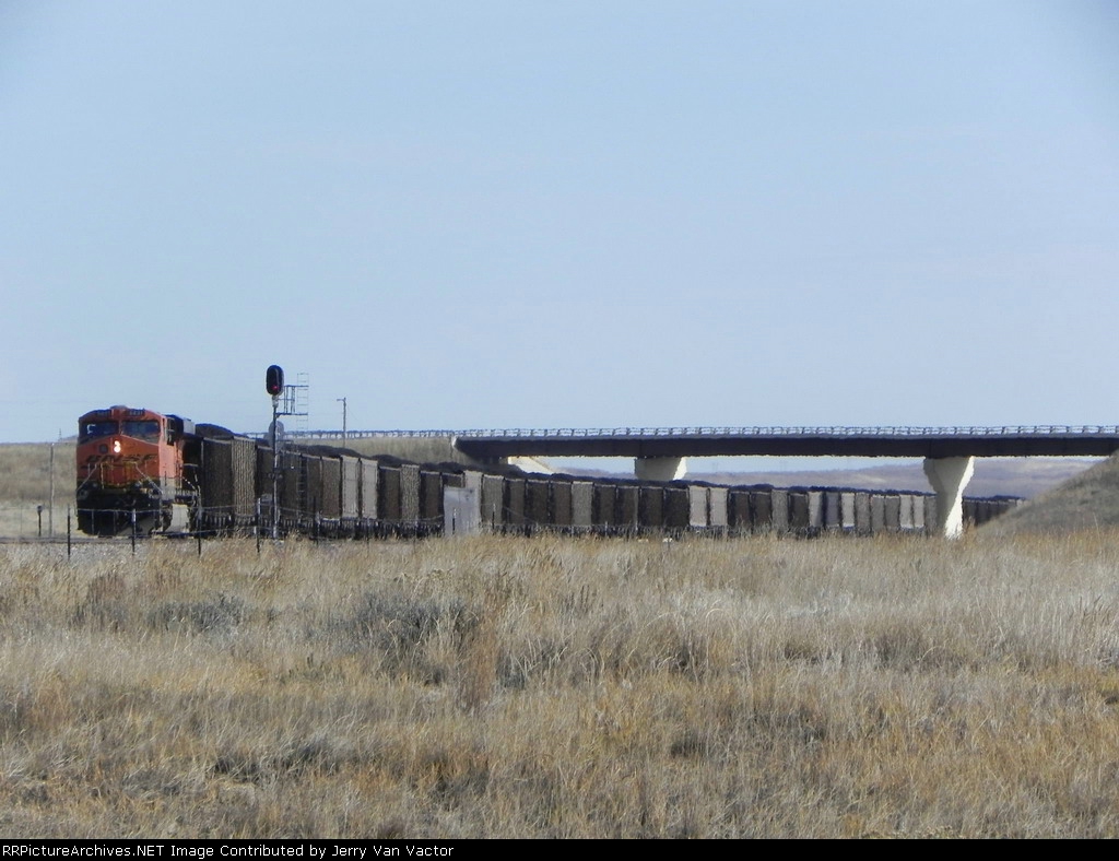 DPU BNSF 6431 about to disappear in the east under state highway 51 about 4m east of Rozet